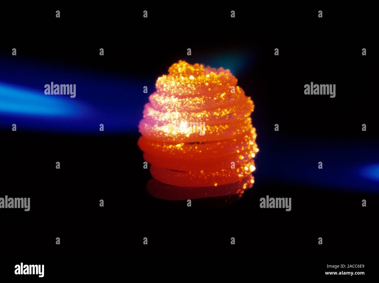 Red hot wire. A coil of copper wire glowing red hot as it is heated by ...