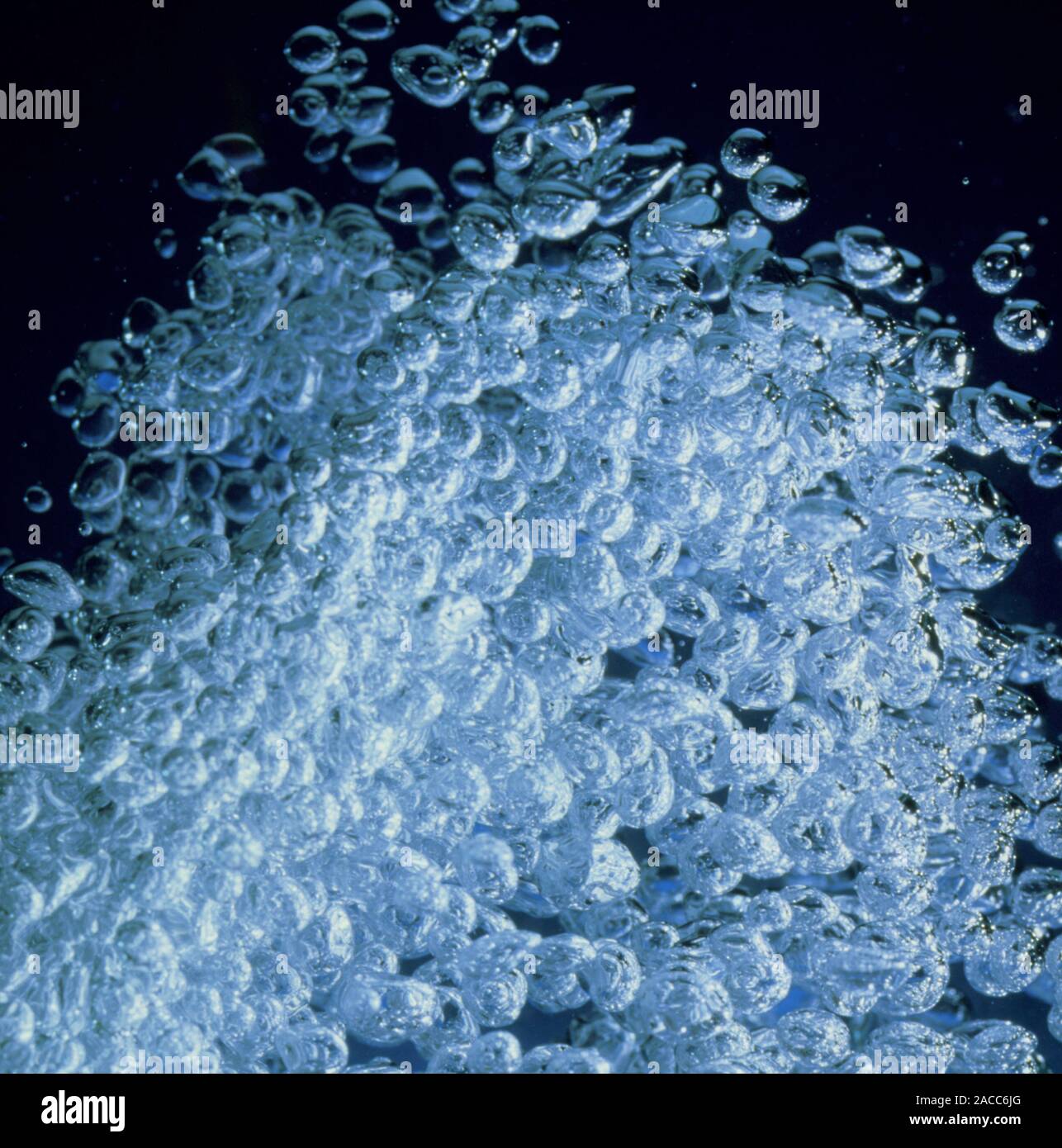 Air bubbles in water, captured by electronic flash photography with an ...