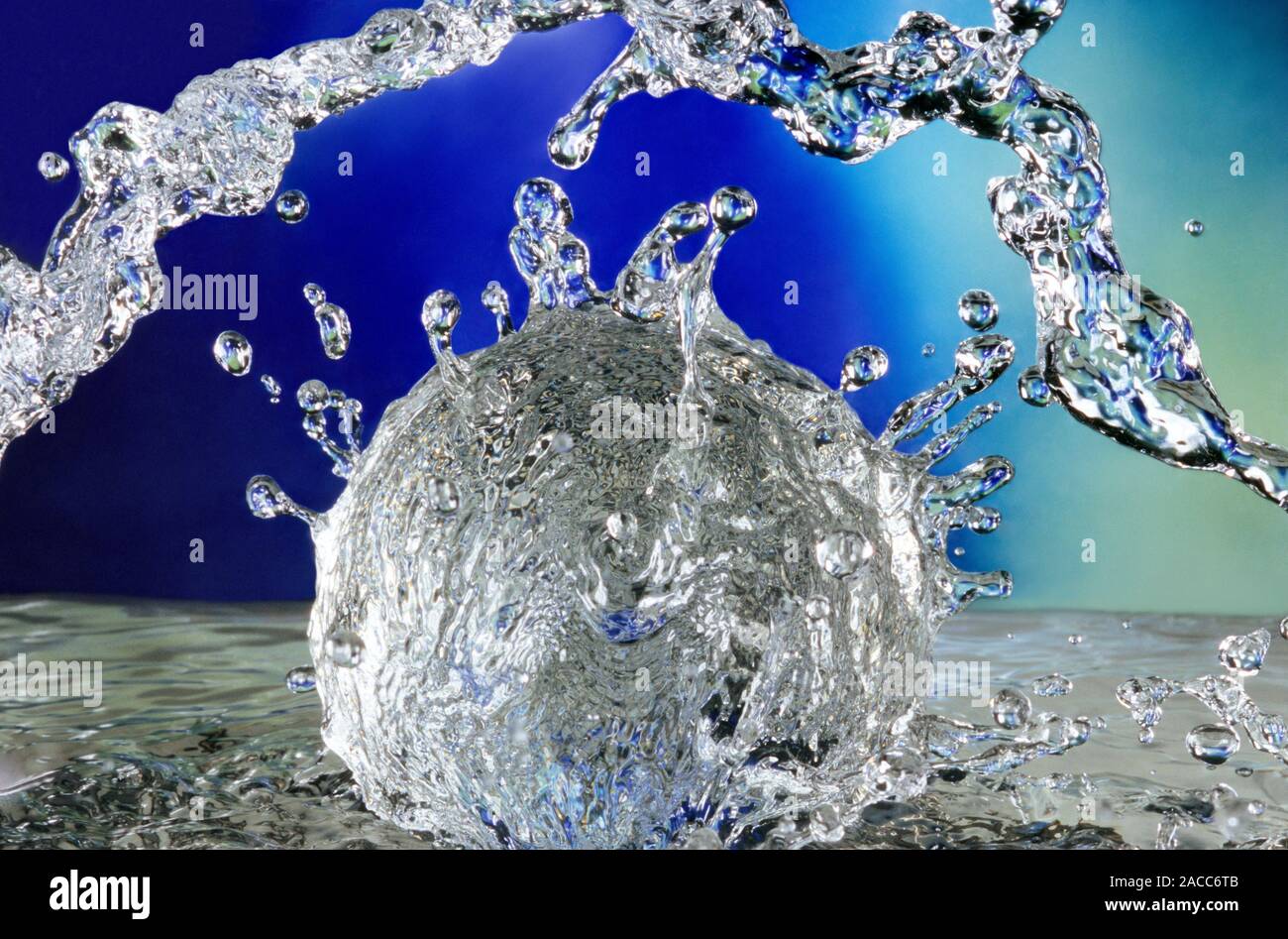 Water falling onto a glass sphere, high-speed photograph. Demonstrating ...