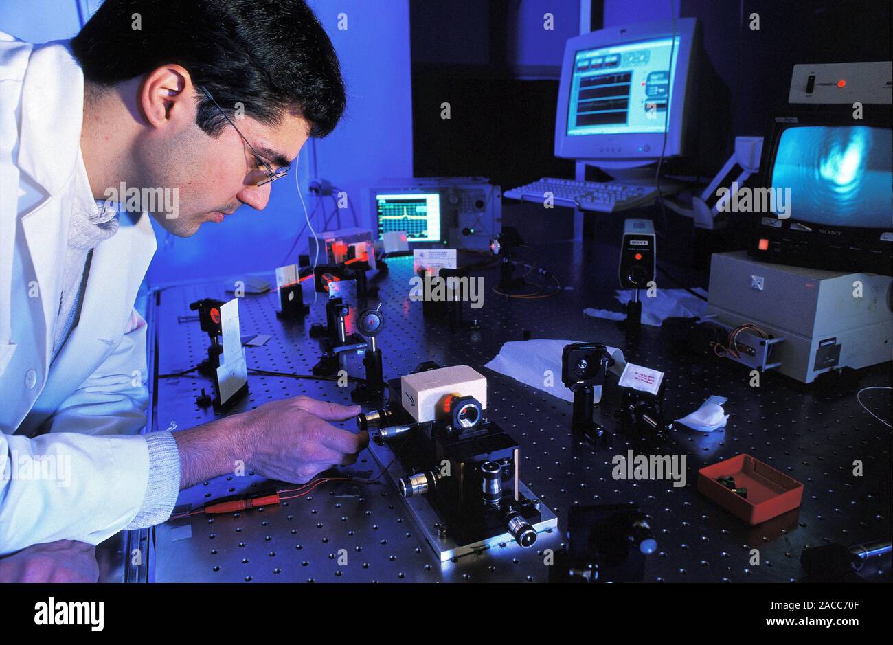Quantum entanglement experiment. Researcher using laser equipment to ...
