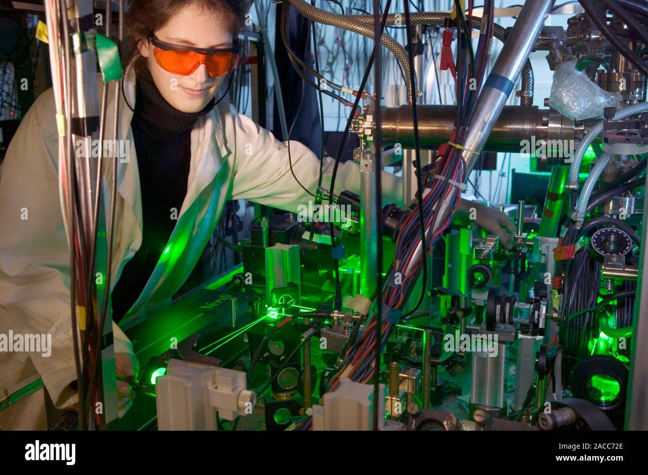 Bose-Einstein condensate research. Scientist working with lasers to ...