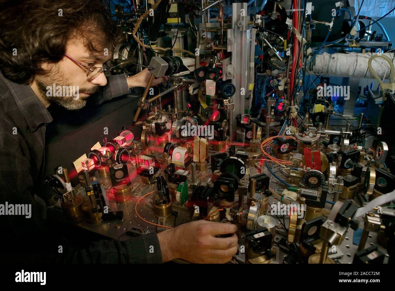 Fermionic condensate research. Scientist working with lasers to create ...