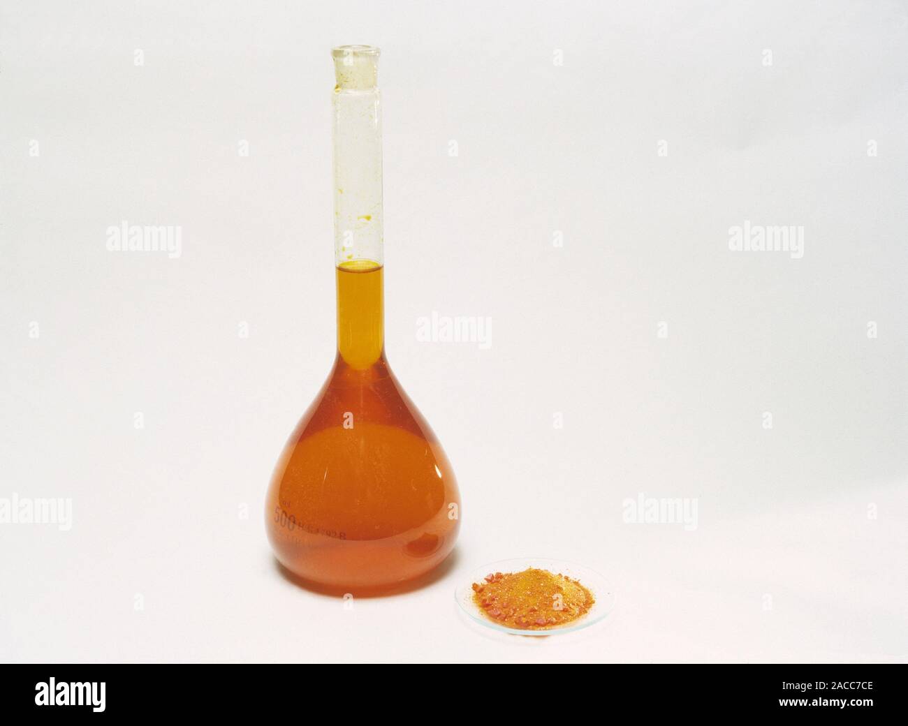 Sodium dichromate (Na2Cr2O7) solution in a volumetric flask, with ...