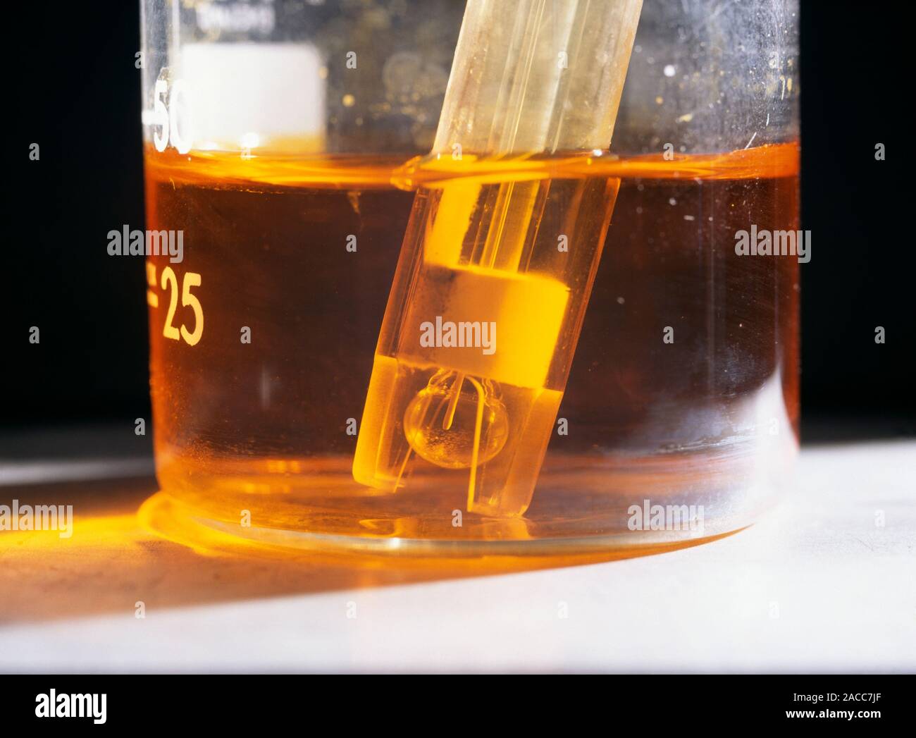 Measuring acidity using a pH meter probe. The tip of the probe is ...