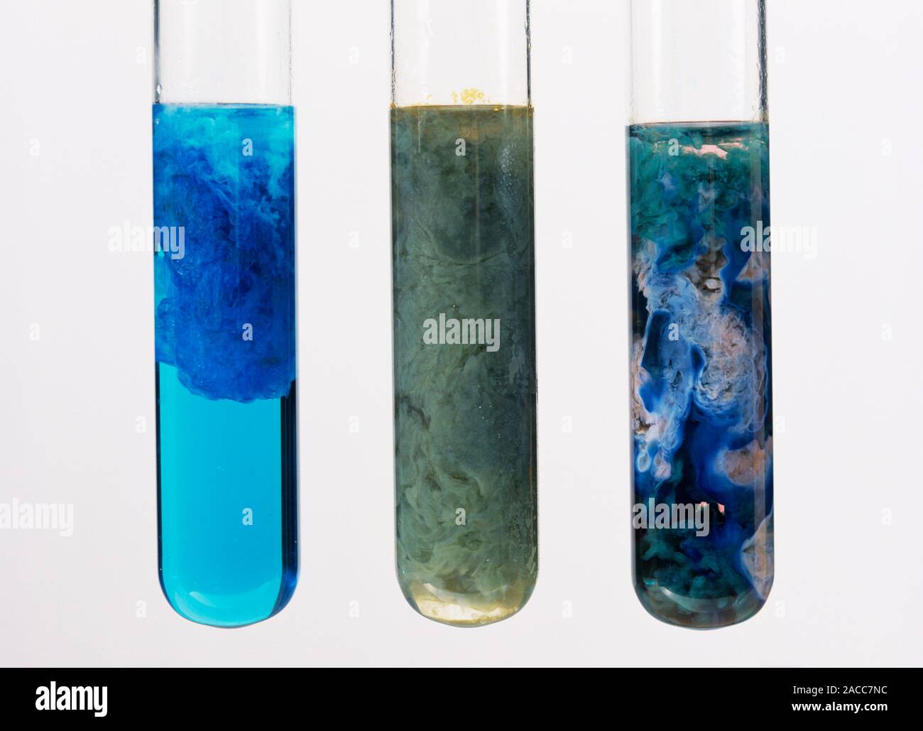 Hydroxide precipitates. Three test tubes containing, from the left ...