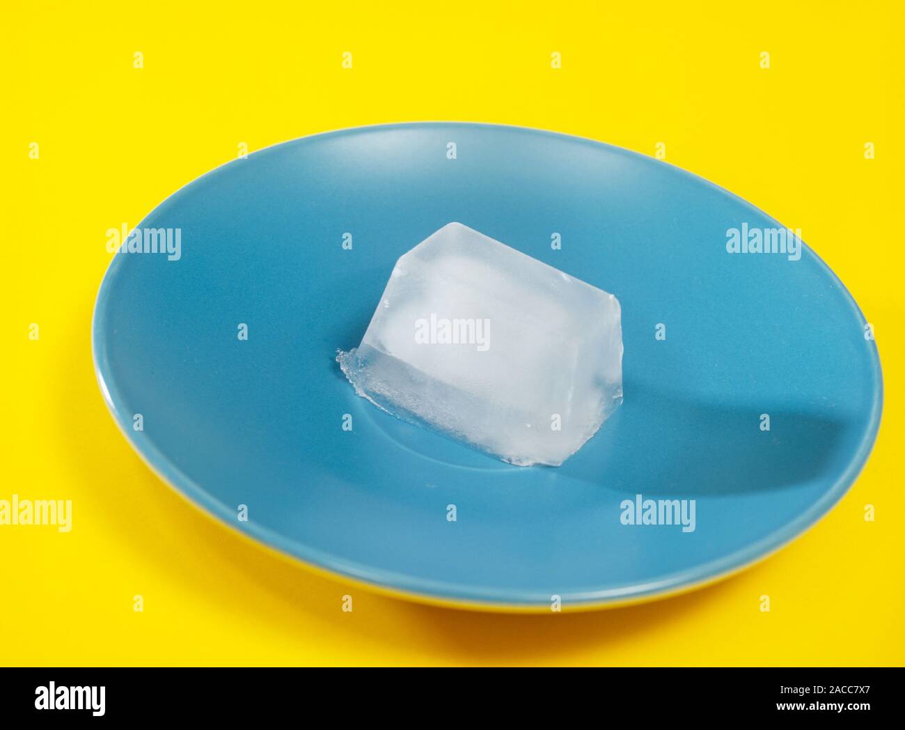 Ice cube melting on a plate. Image 1 of 2. Ice is the solid form of ...