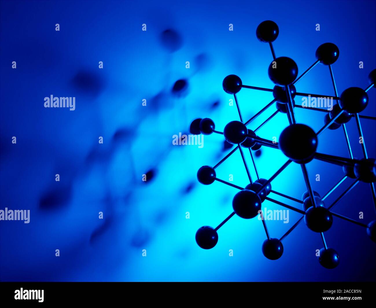 Molecular model. Plastic molecular model casting a shadow on a wall ...