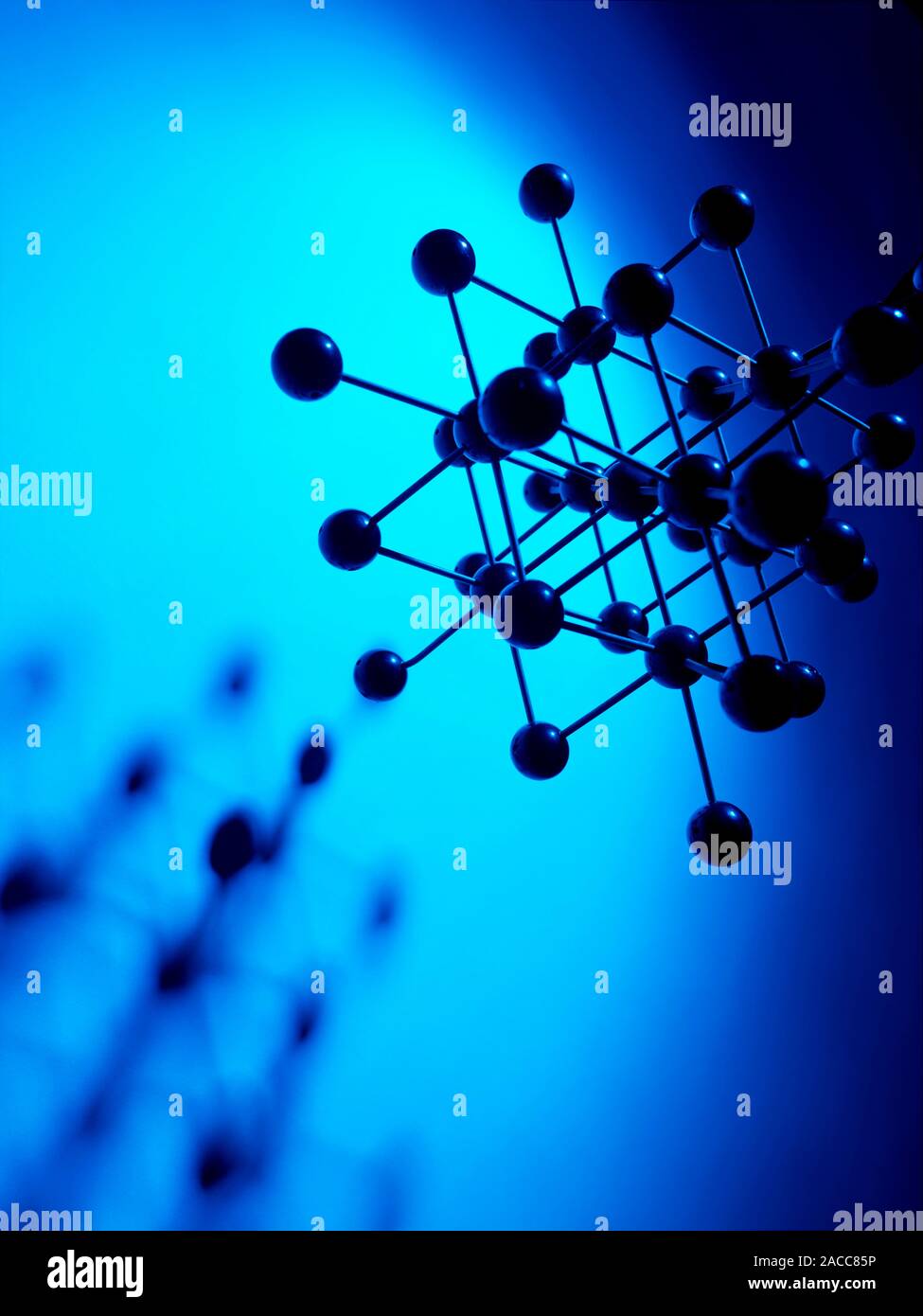 Molecular model. Plastic molecular model casting a shadow on a wall ...