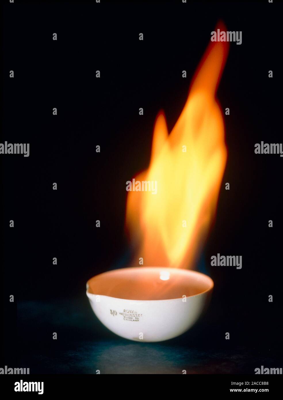 Burning petrol. Flames from a sample of burning petrol in a crucible ...