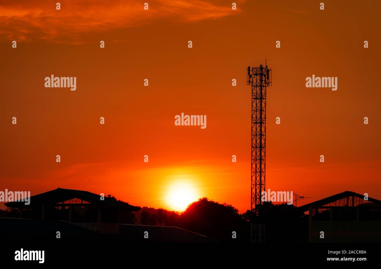 Telecommunication tower with red sunset sky and clouds. Radio and ...