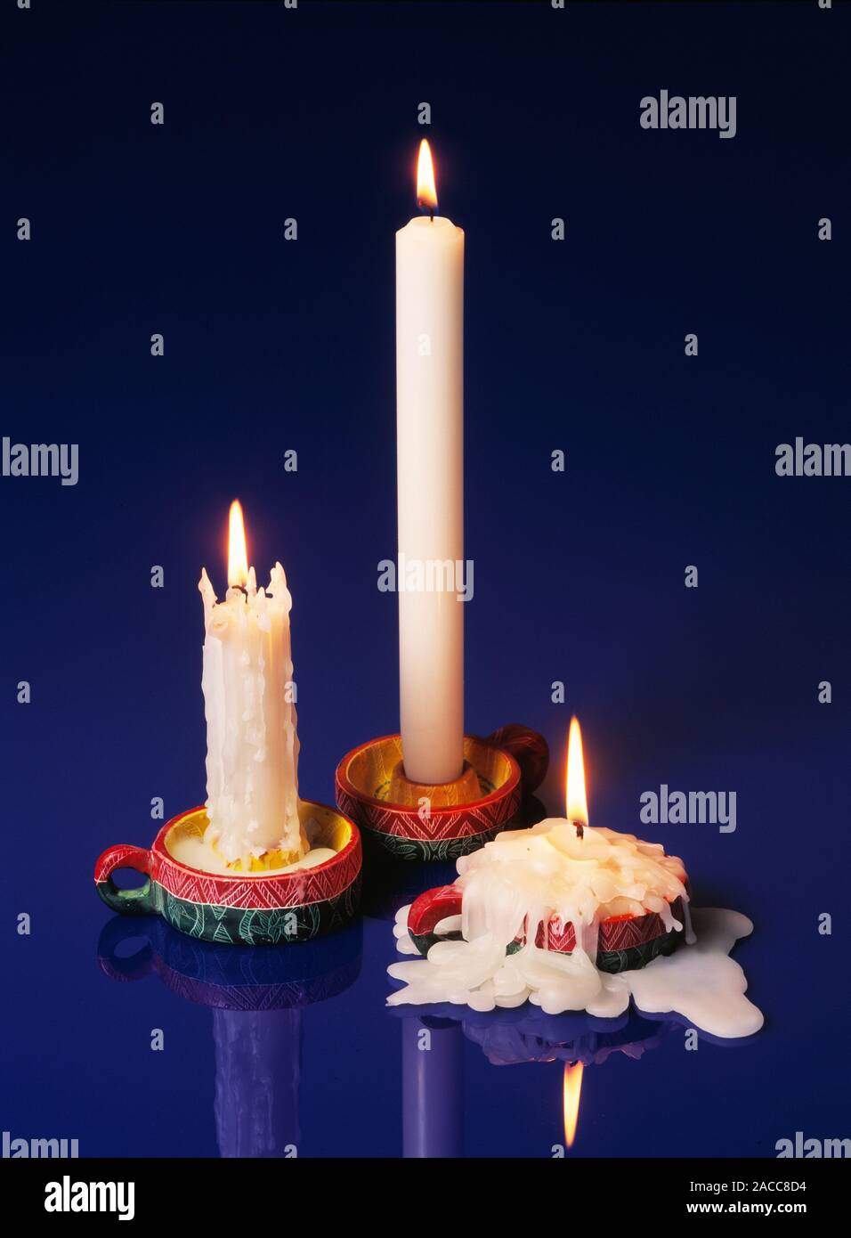 Candles at different stages of burning Stock Photo - Alamy