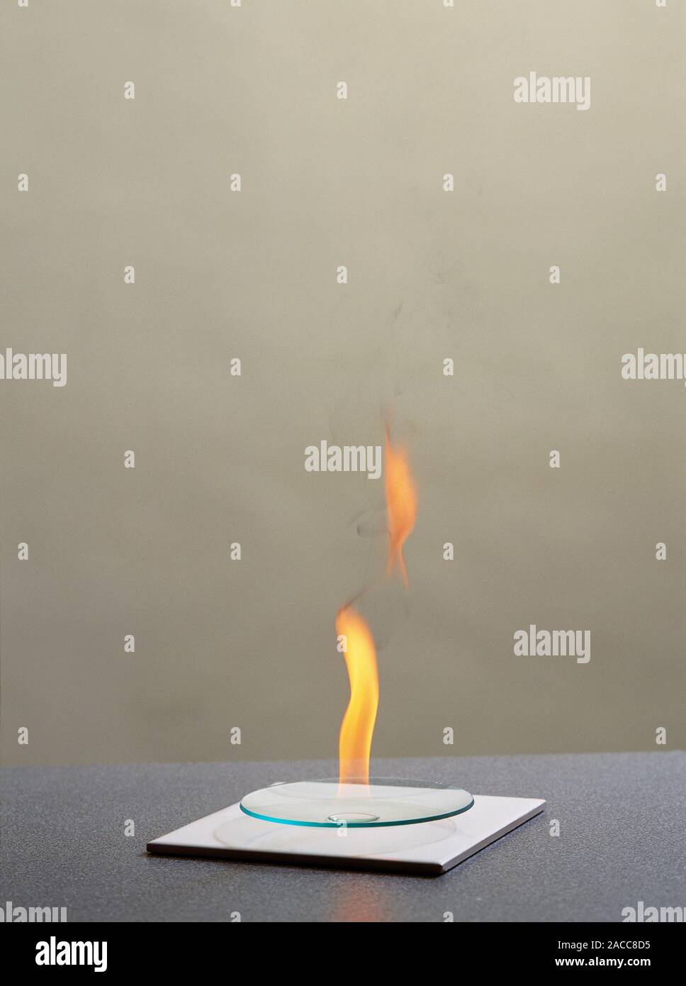 Combustion of an alkane. Hexane (C6H14) burning in a watchglass. Hexane ...