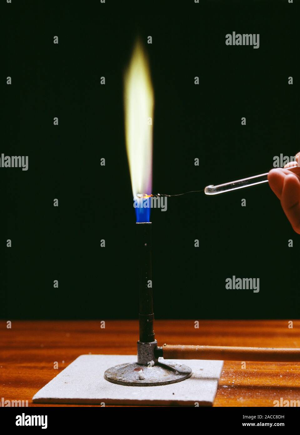 Flame test. Barium burning in the flame of a bunsen burner producing a ...