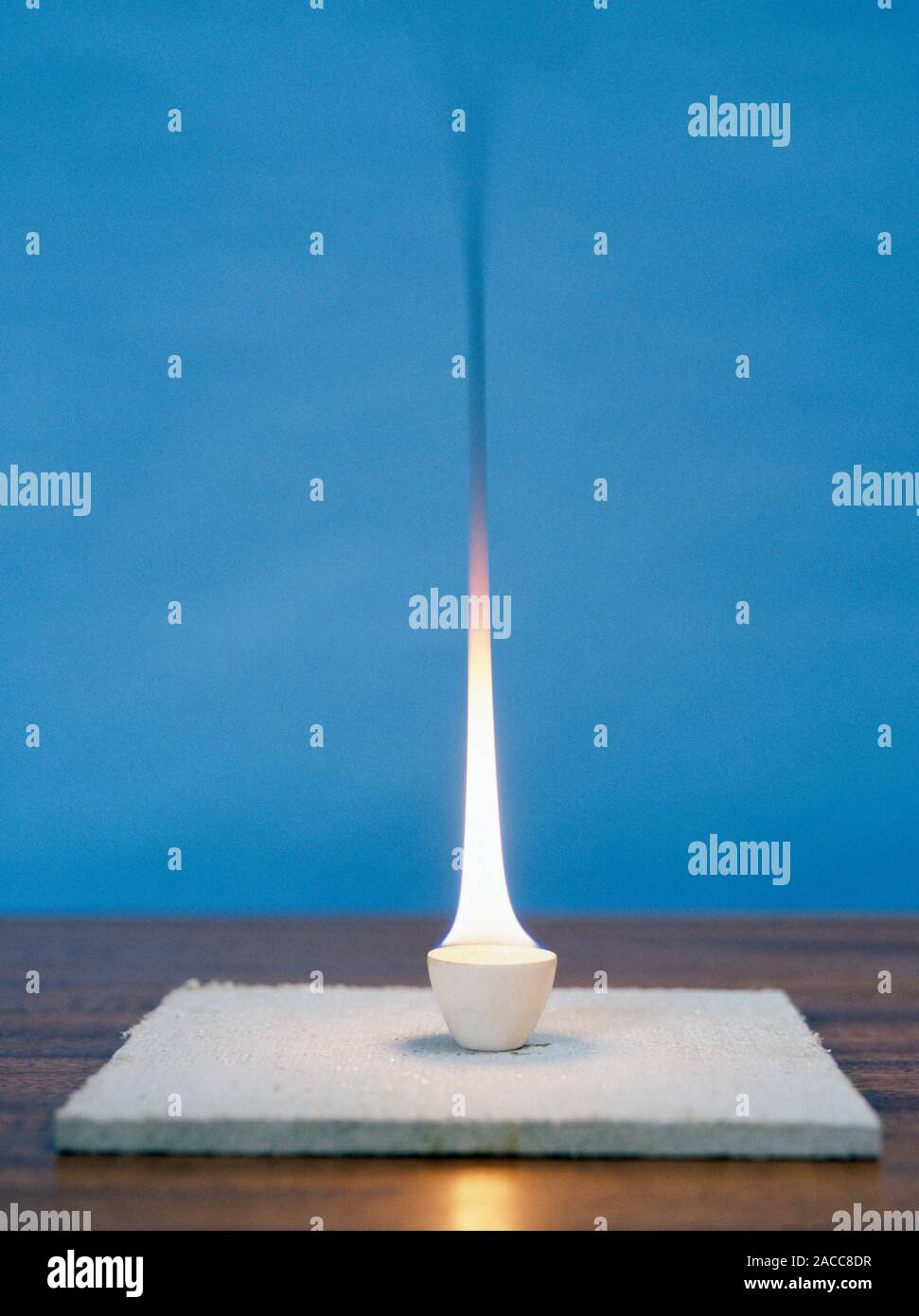 Sooty flame. Alkene (oct-1-ene) burning in a crucible with a sooty ...