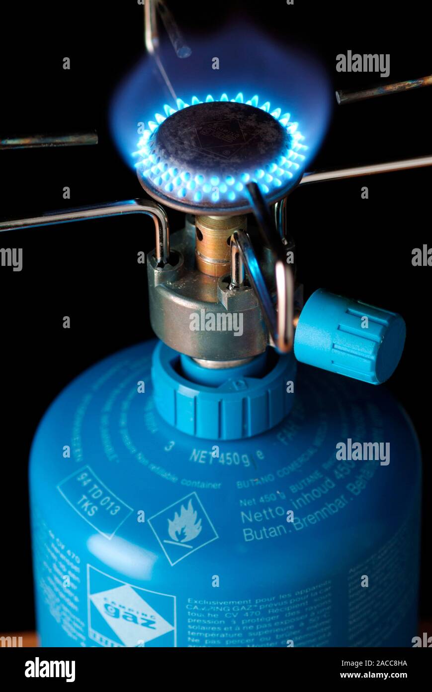 Butane gas camping stove. Gas flame (blue) burning on a camping stove ...