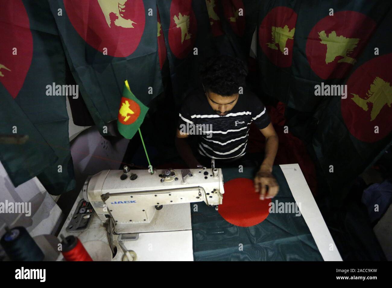 Dhaka, Bangladesh. 2nd Dec, 2019. A tailor sews a national flag of ...