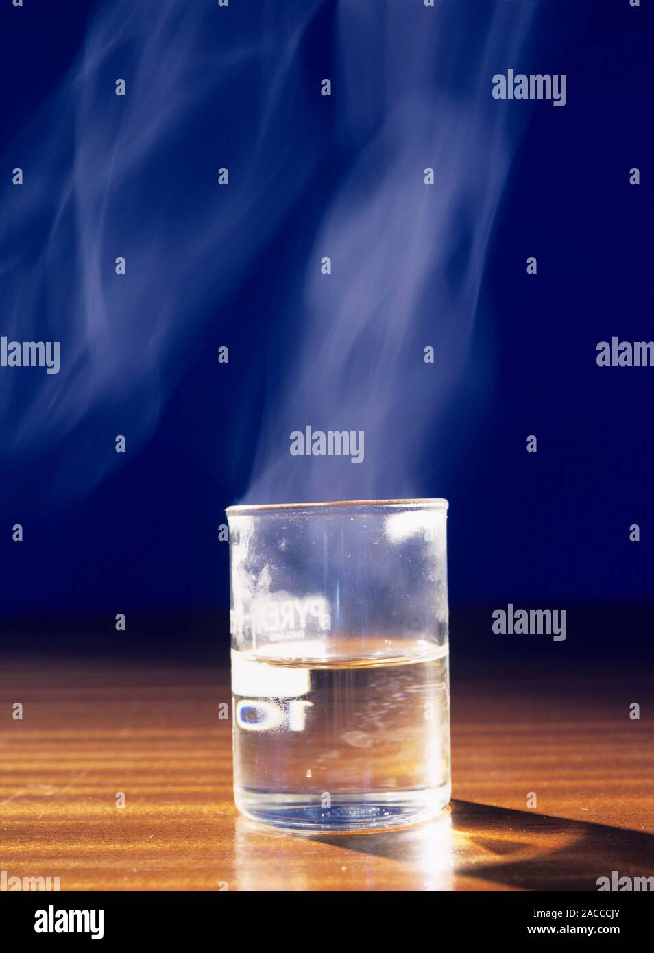 Hydrochloric acid (HCl) in a beaker. This liquid is volatile, as can be ...