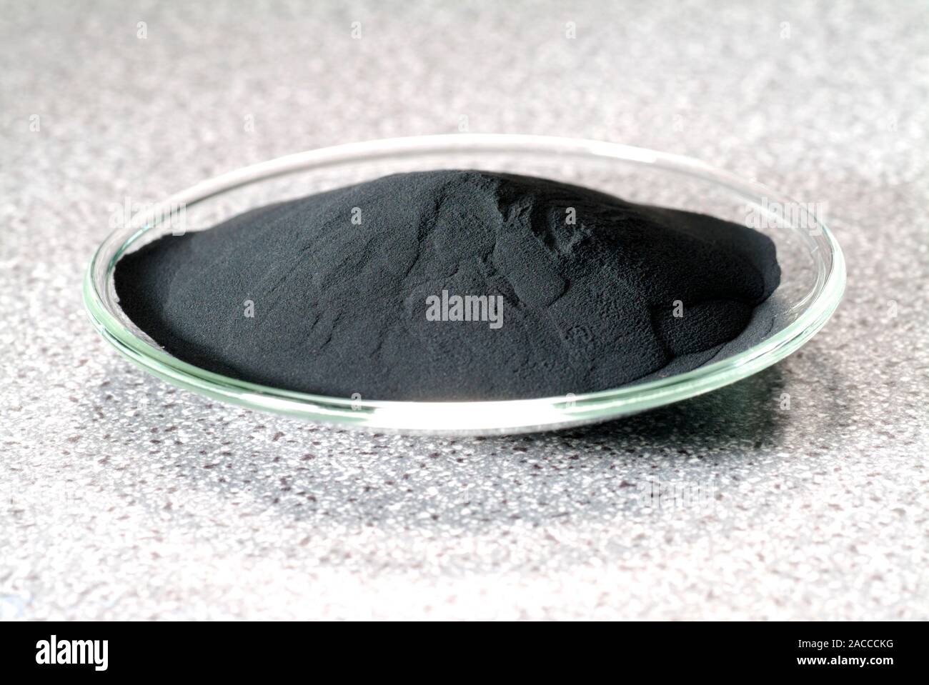 Copper oxide powder on a watch glass. This is copper (II) oxide, CuO ...
