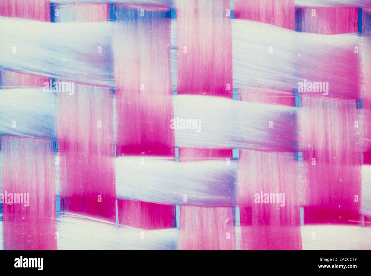 Macrophotograph of woven glass fibres. Fine fibres of glass are woven ...