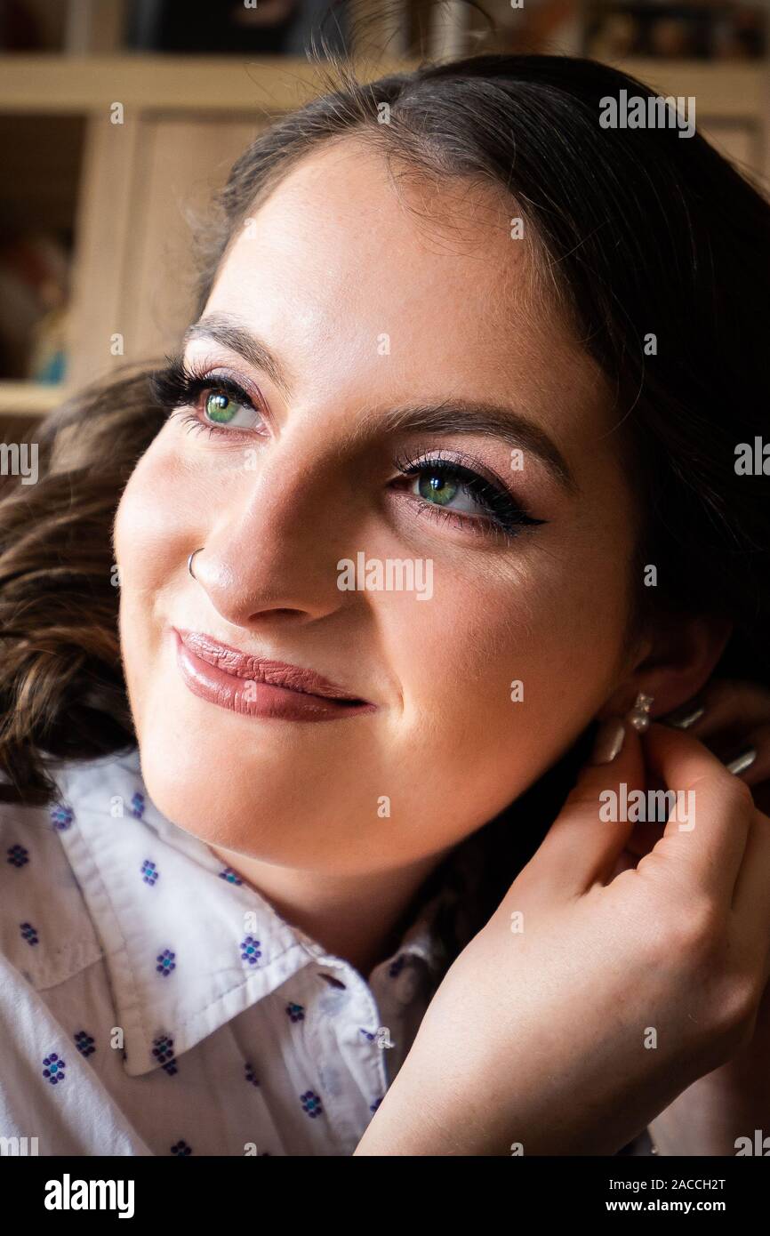 A pretty, beautiful women gets ready to be a Bride for the day, having ...