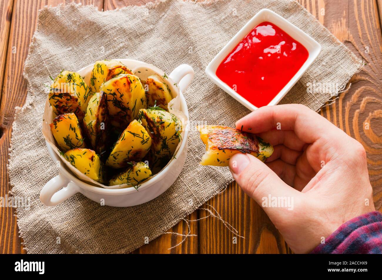 man eating fried potatoes with ketchup Stock Photo - Alamy