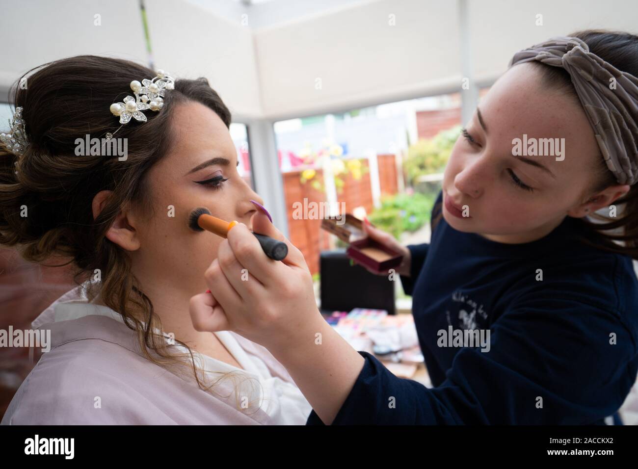 A pretty, beautiful women gets ready to be a Bride for the day, having ...