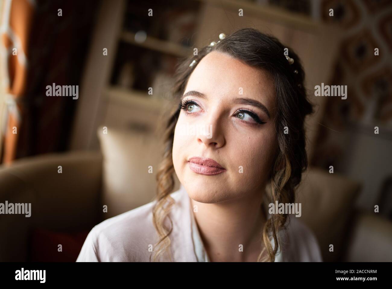 A pretty, beautiful women gets ready to be a Bride for the day, having ...