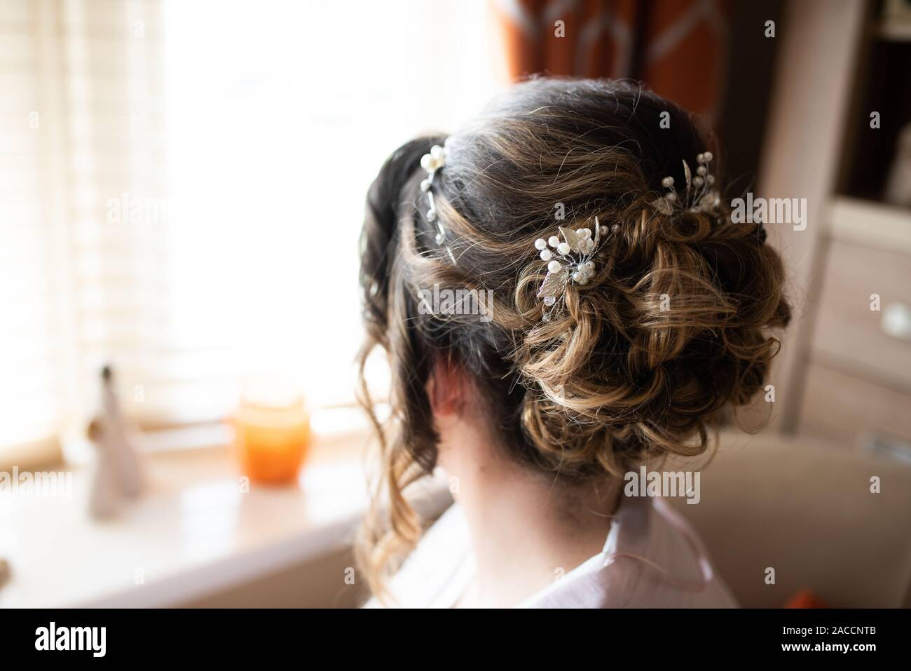 A pretty, beautiful women gets ready to be a Bride for the day, having ...