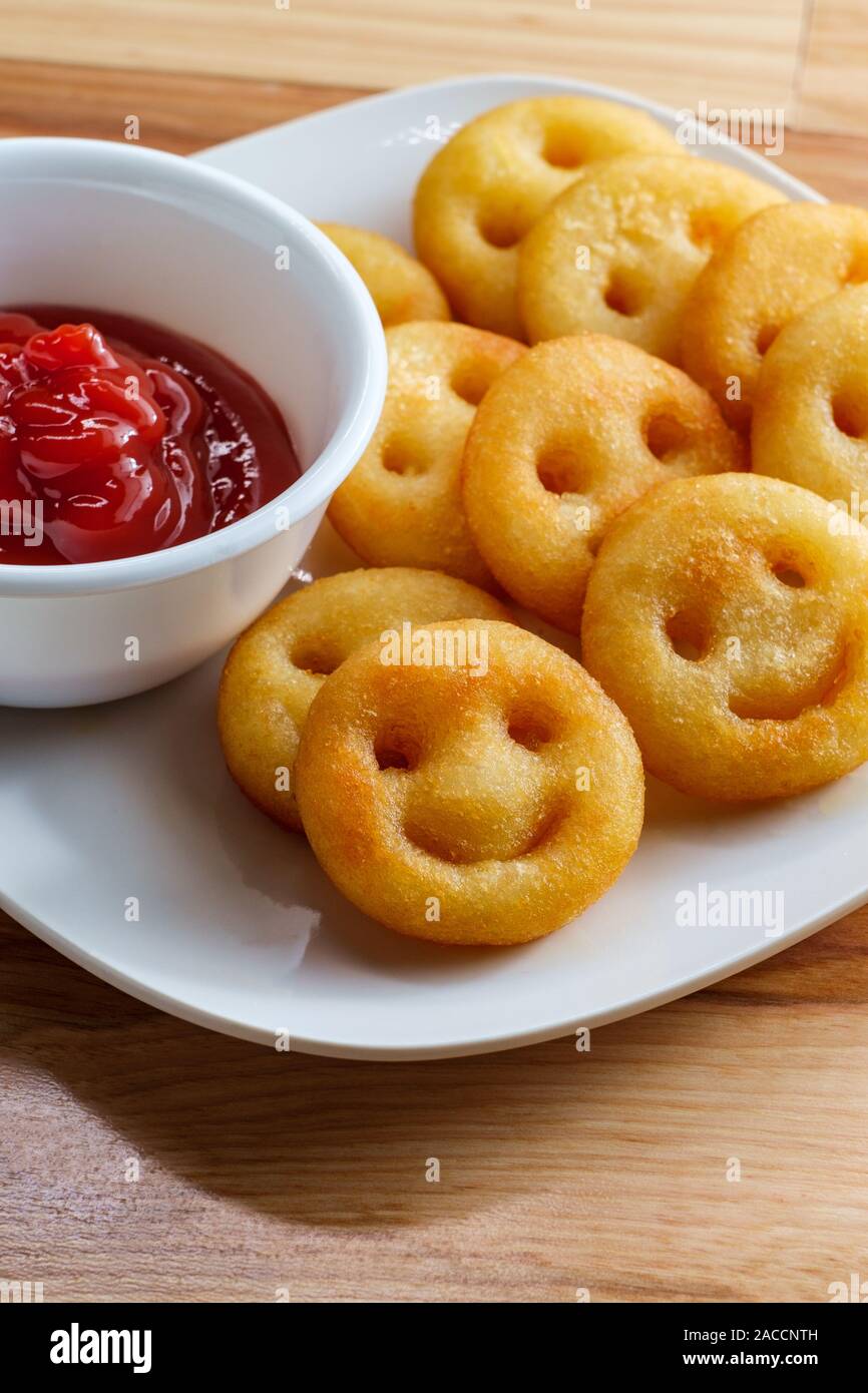 Happy French fried potato smiley faces with ketchup Stock Photo - Alamy