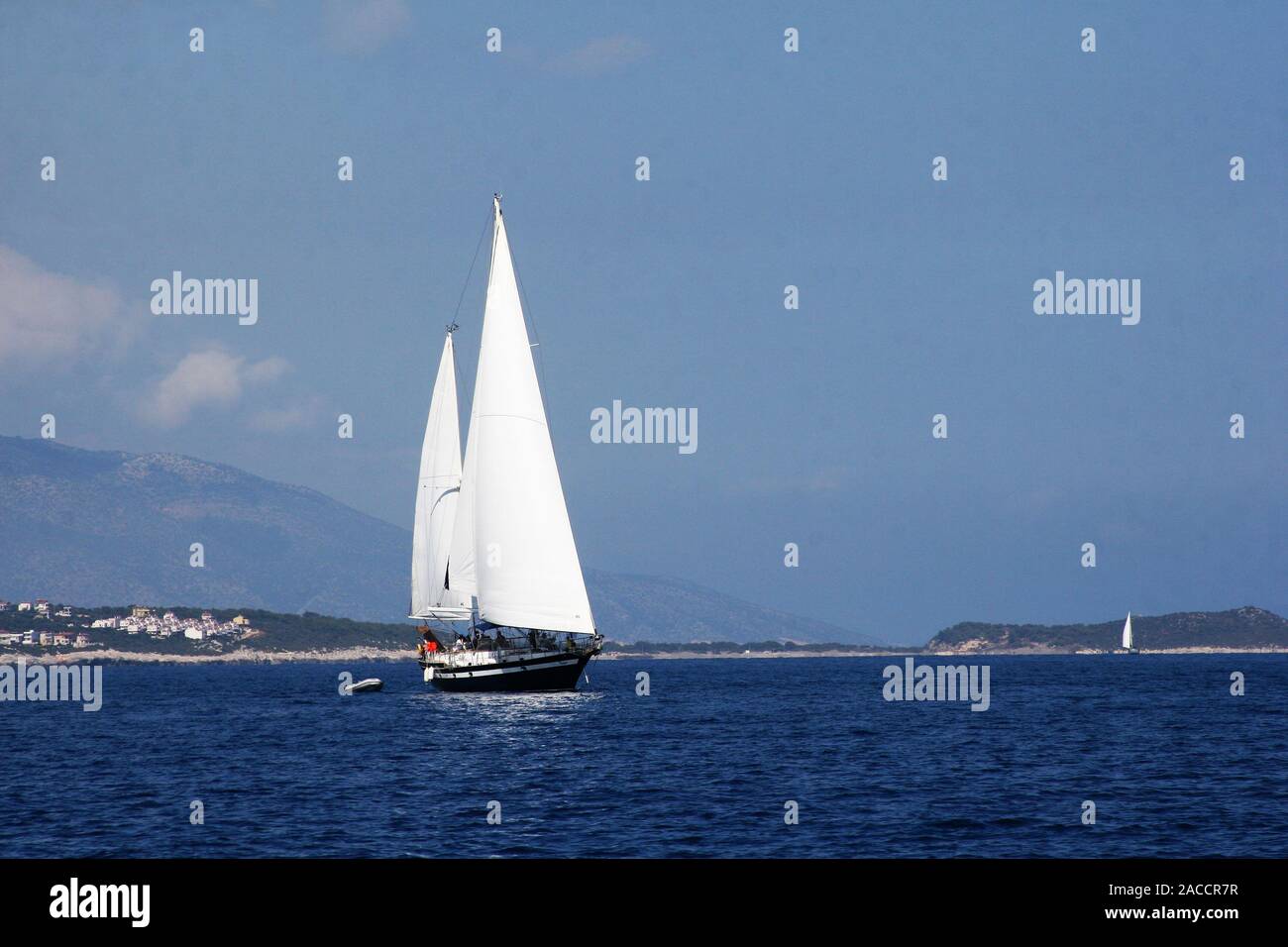 sailboat floating on the sea with a deflated sails Stock Photo - Alamy