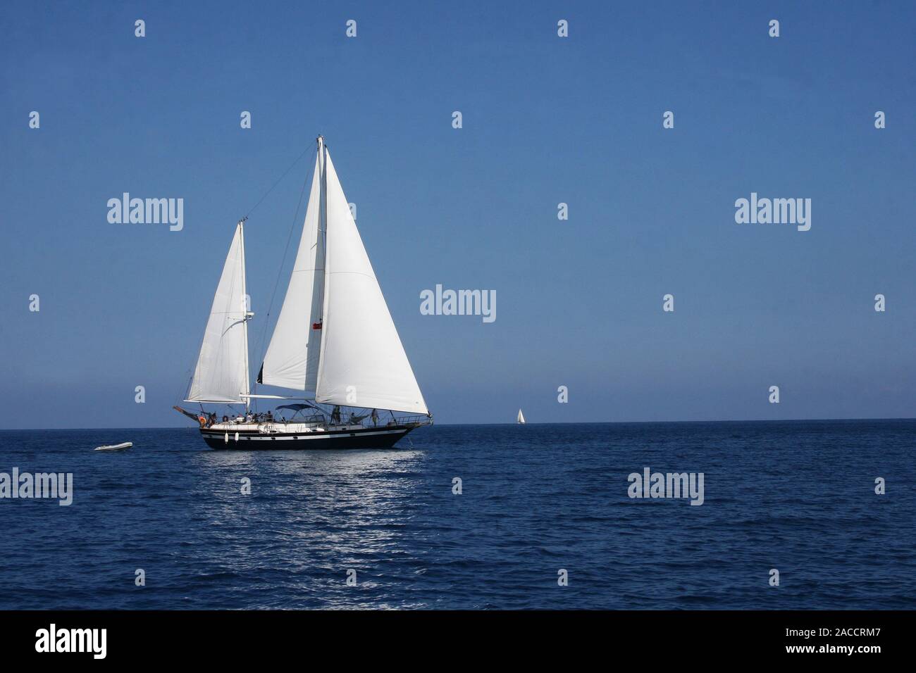 sailboat floating on the sea with a deflated sails Stock Photo - Alamy