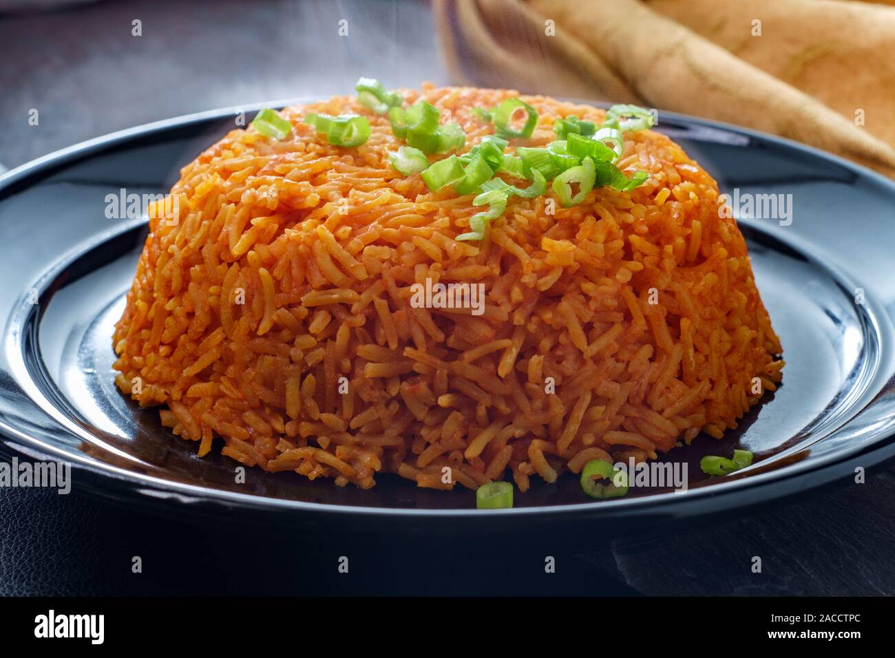 Colombian cuisine red rice with green onion garnish Stock Photo - Alamy