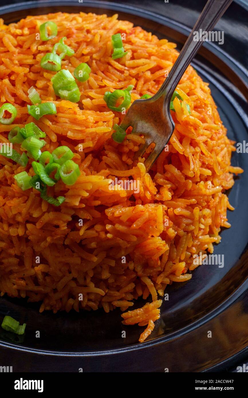 Colombian cuisine red rice with green onion garnish Stock Photo - Alamy