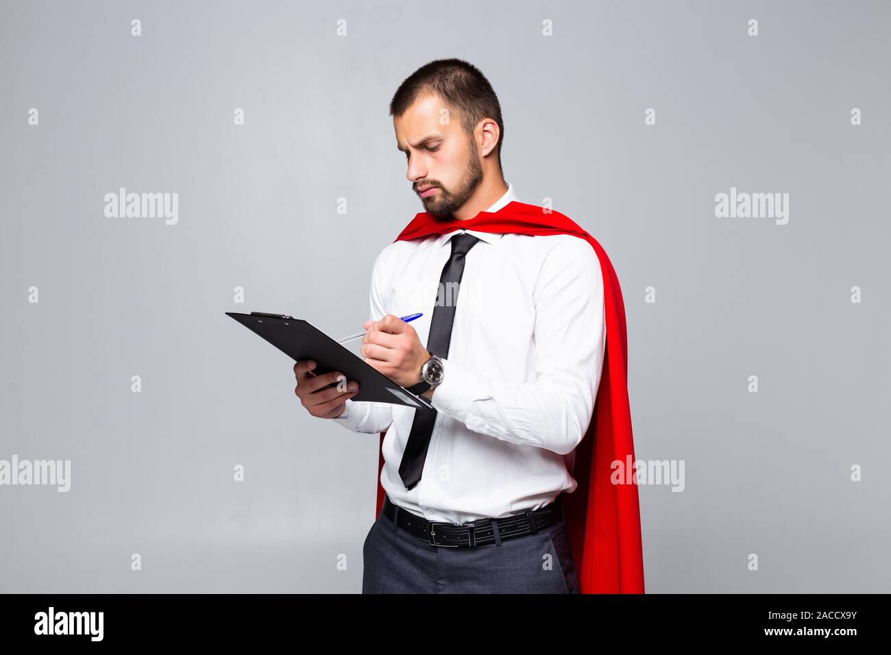 Young businessman superhero with blank make notice on white background ...