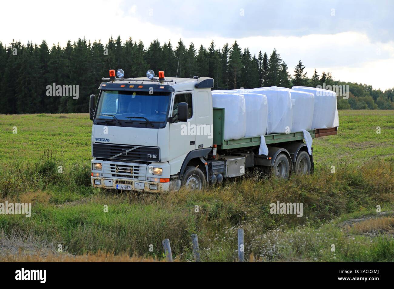 SALO, FINLAND - SEPTEMBER 6, 2014: A flat bed Volvo FH12 truck ...