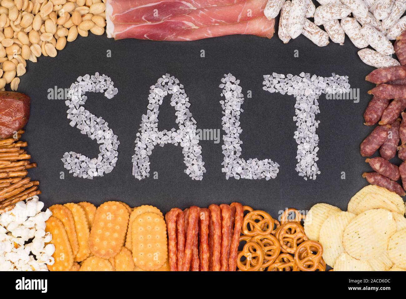 Word salt written with sea salt crystals surrounded by food containing ...