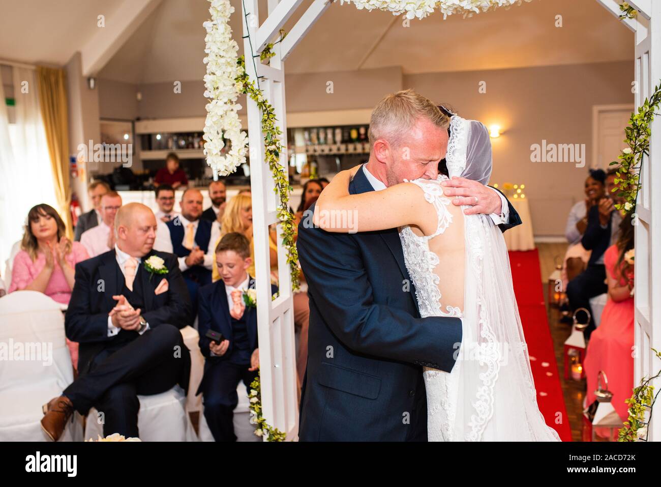 A couple get married indoors in a traditional English wedding ceremony ...