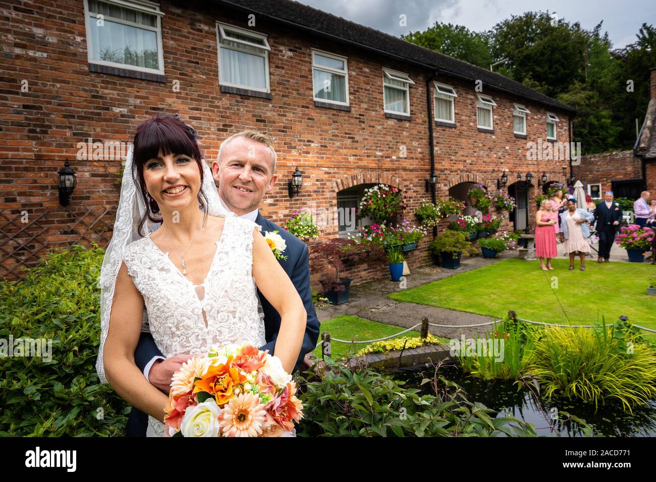 Bride and Groom pose for their after ceremony pictures in the gardens ...