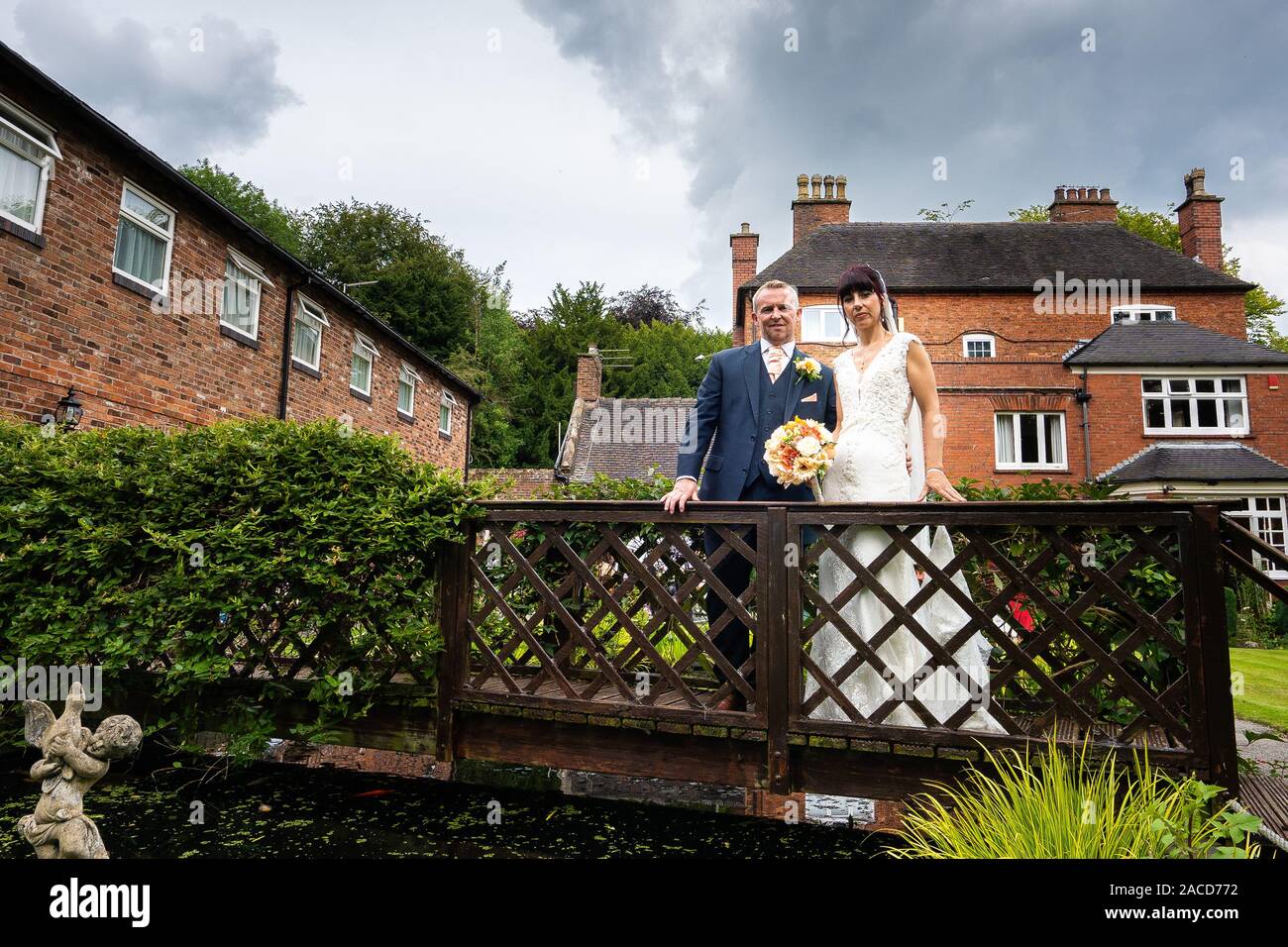 Bride and Groom pose for their after ceremony pictures in the gardens ...