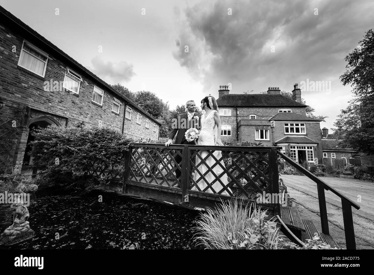 Bride and Groom pose for their after ceremony pictures in the gardens ...