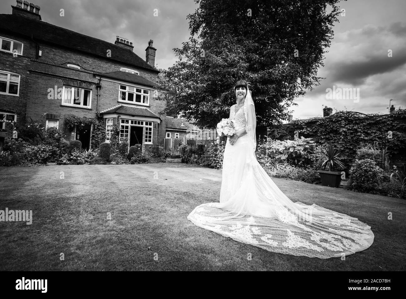 A bride poses for her after ceremony pictures in the gardens at the ...
