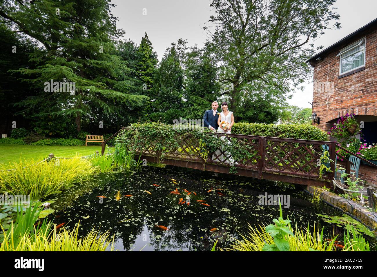 Bride and Groom pose for their after ceremony pictures in the gardens ...