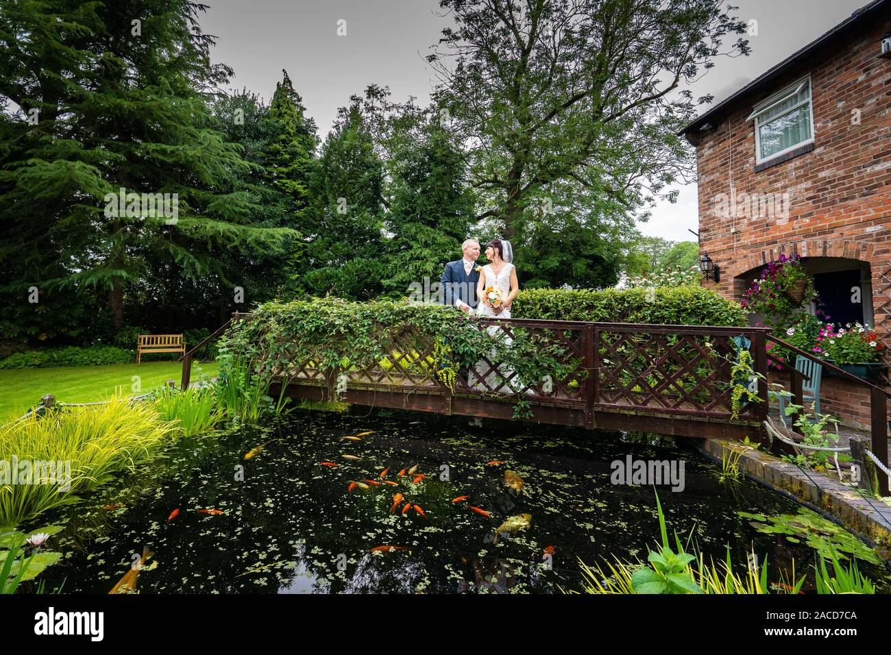Bride and Groom pose for their after ceremony pictures in the gardens ...