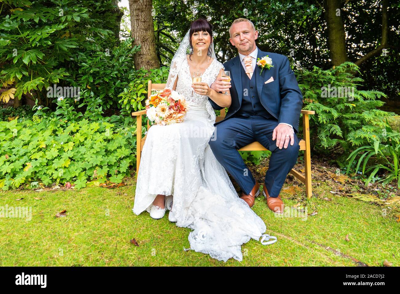Bride and Groom pose for their after ceremony pictures in the gardens ...