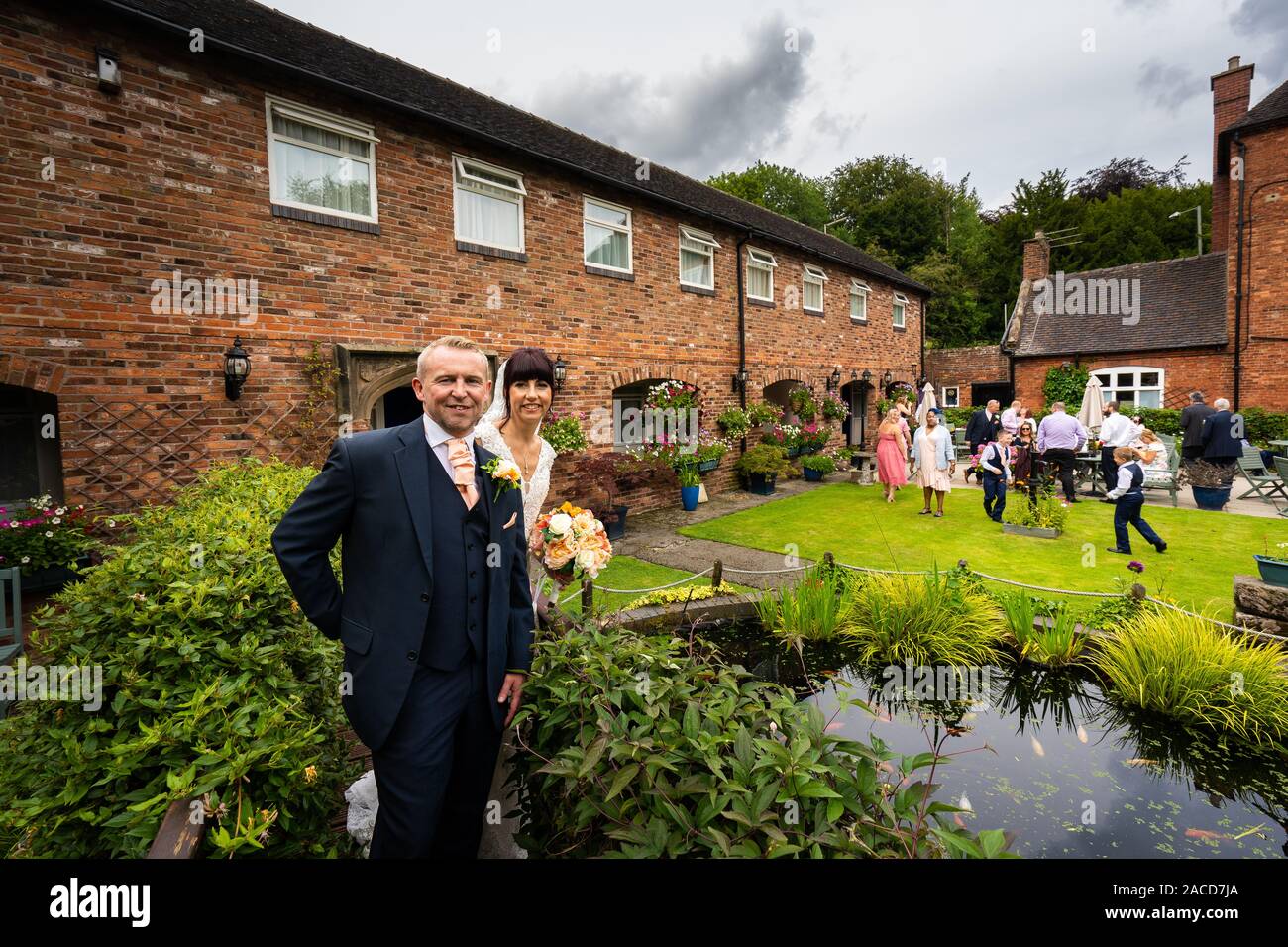Bride and Groom pose for their after ceremony pictures in the gardens ...
