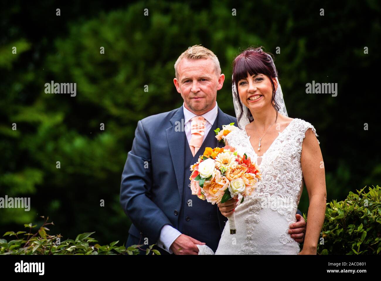 Bride and Groom pose for their after ceremony pictures in the gardens ...