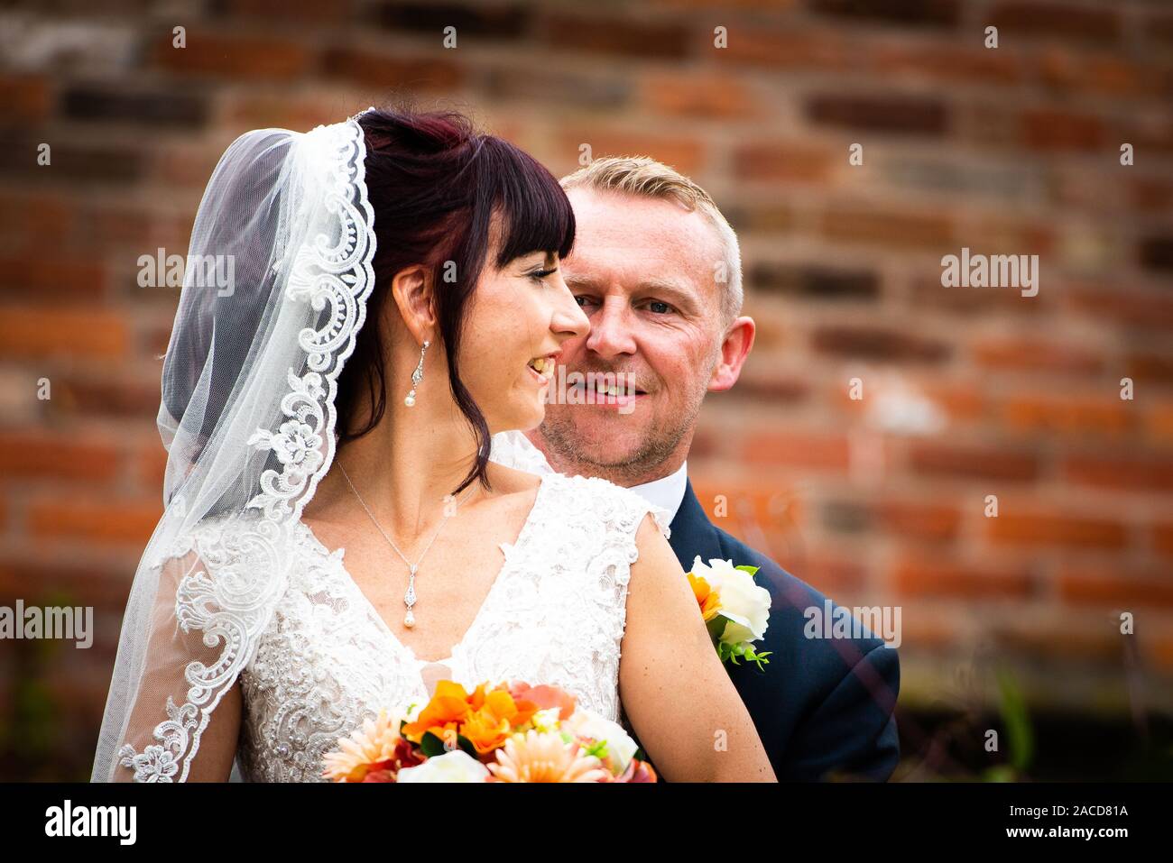 Bride and Groom pose for their after ceremony pictures in the gardens ...