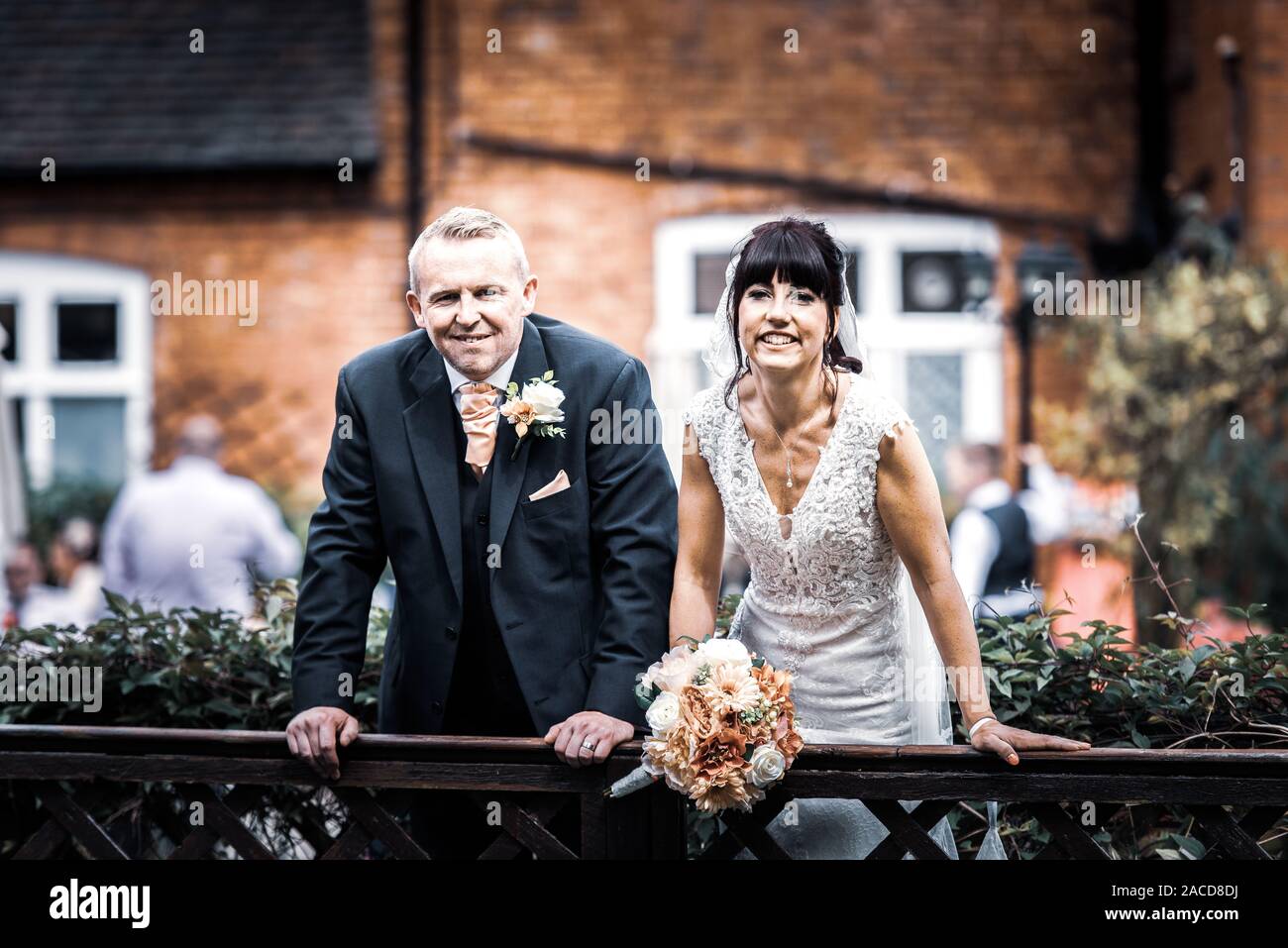 Bride and Groom pose for their after ceremony pictures in the gardens ...