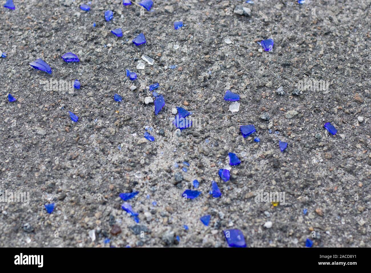Blue broken glass on the asphalt Stock Photo - Alamy