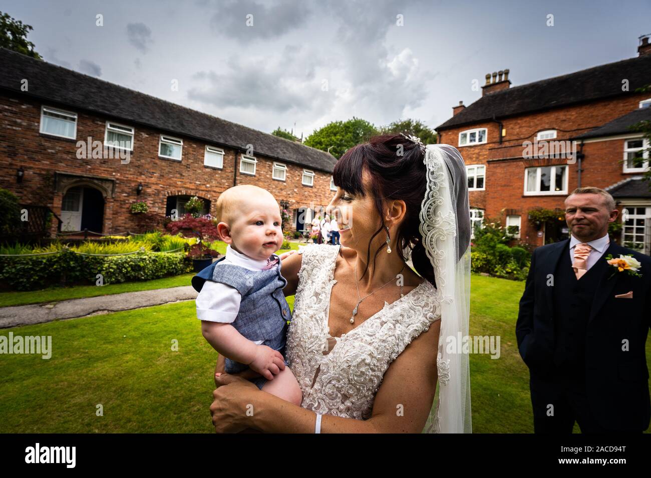 A bride, mother poses with her baby boy after getting married in the ...